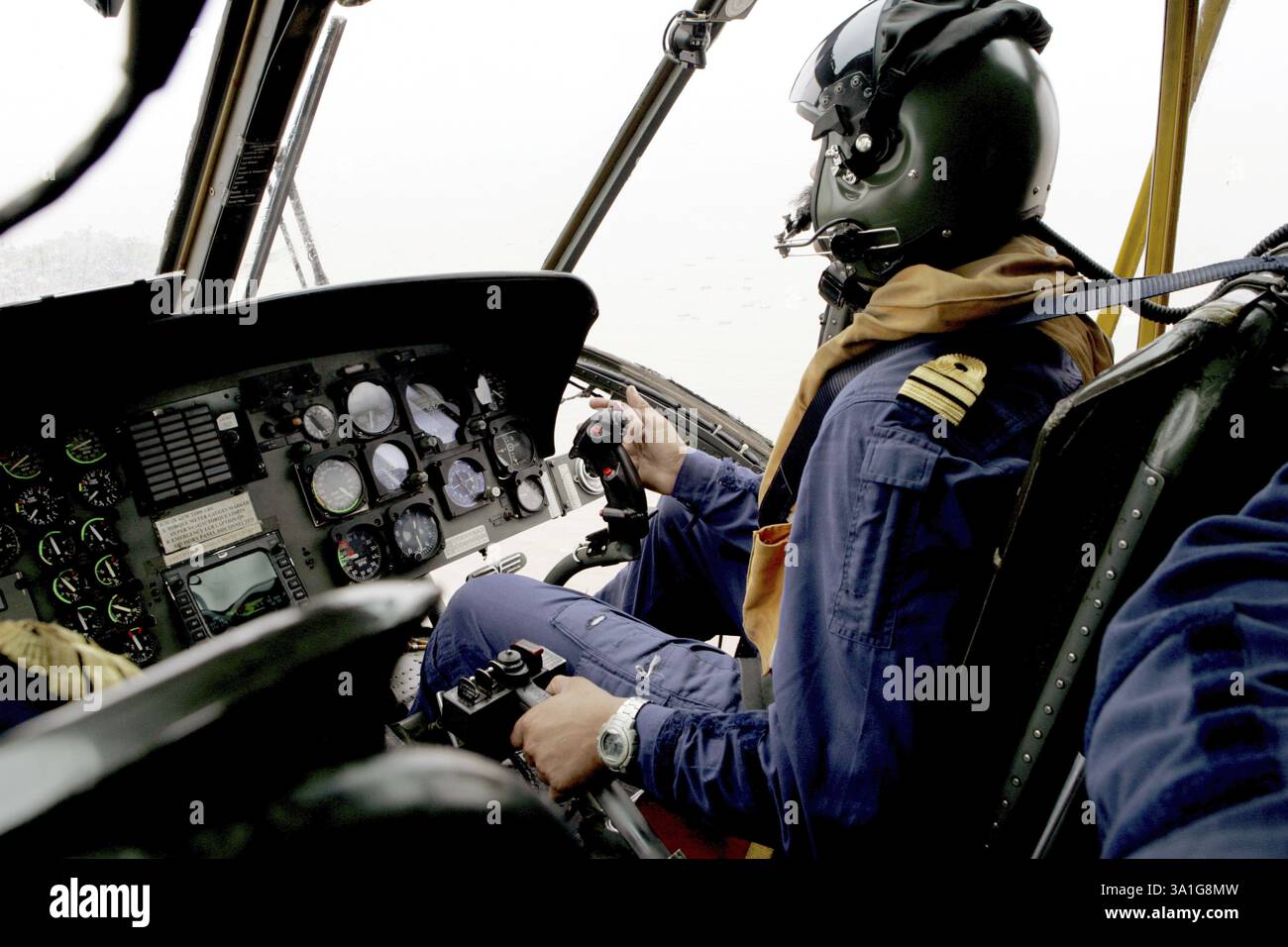 Indian Navy helicopter pilot sitting navigating areas in and around of ...