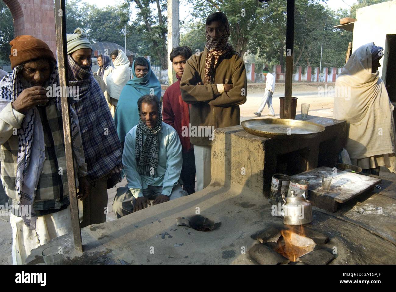 People at tea stall enjoying cup of tea in rural India, Betla National ...