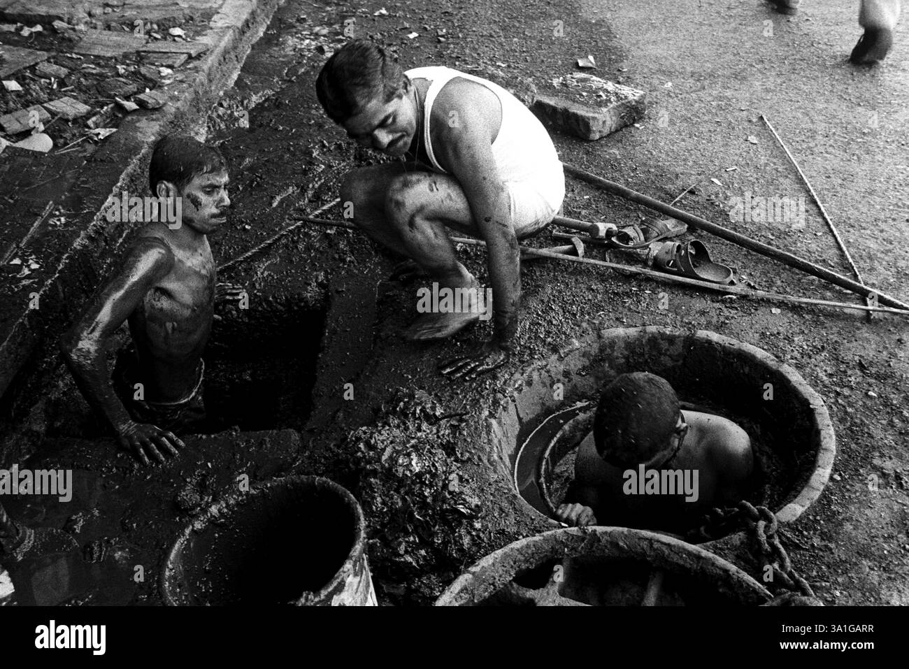 Men cleaning drainage Stock Photo - Alamy