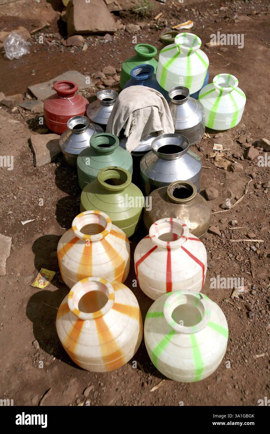Queue of plastic pitchers waiting for water supply, Bassapur village ...