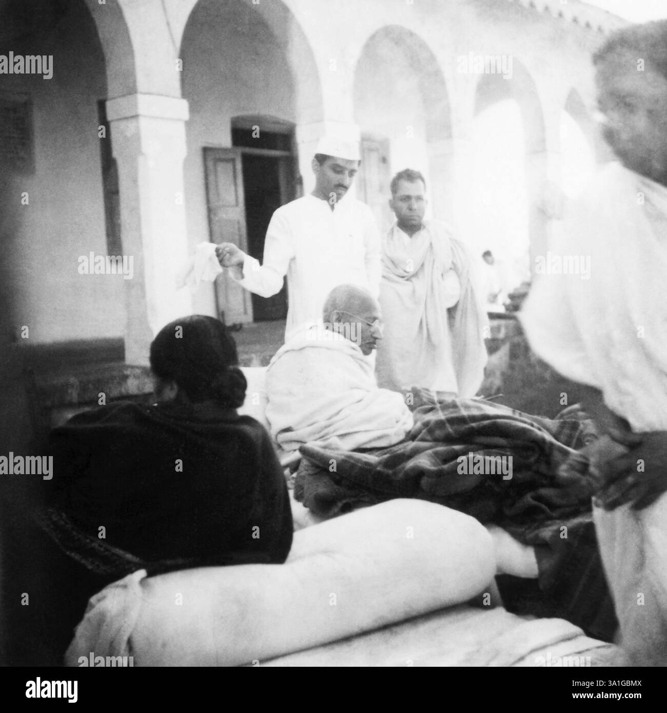 Mahatma Gandhi sitting in front of the main building at Rashtriyashala ...