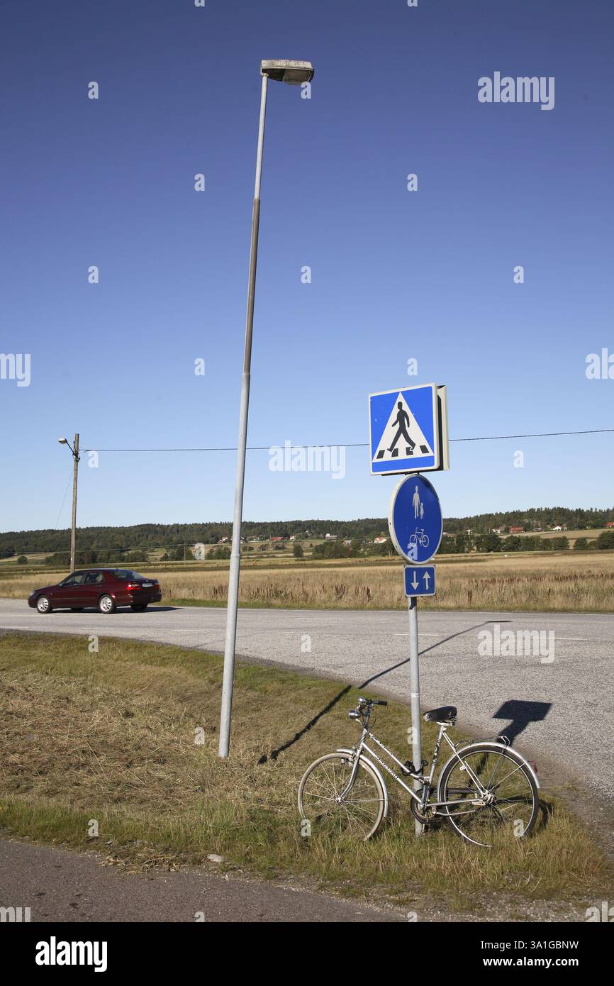 Road sign of pedestrian crossing cycle supported locked with pole ...