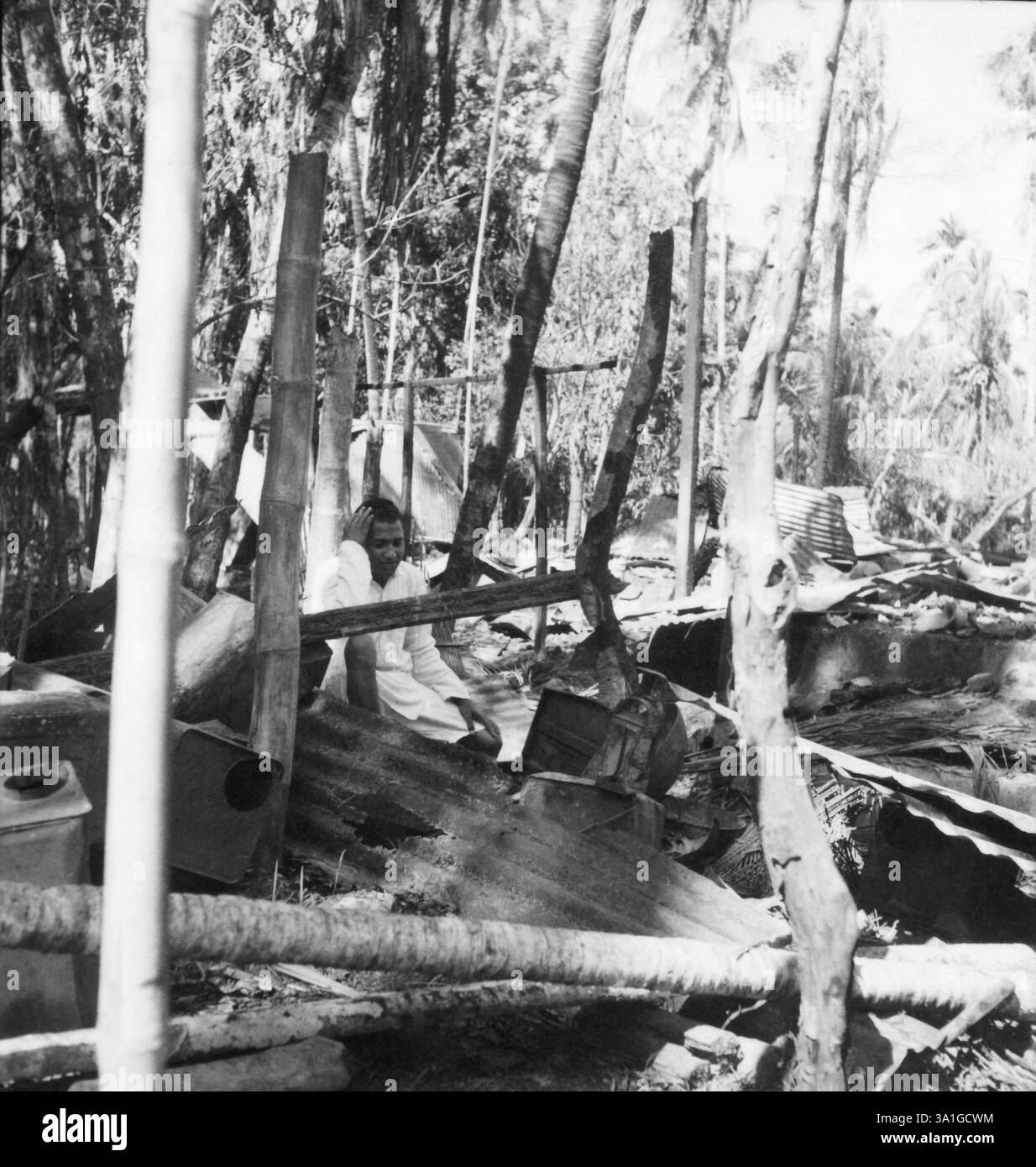 A weeping man sitting in midst of destruction caused by Hindu Muslim ...