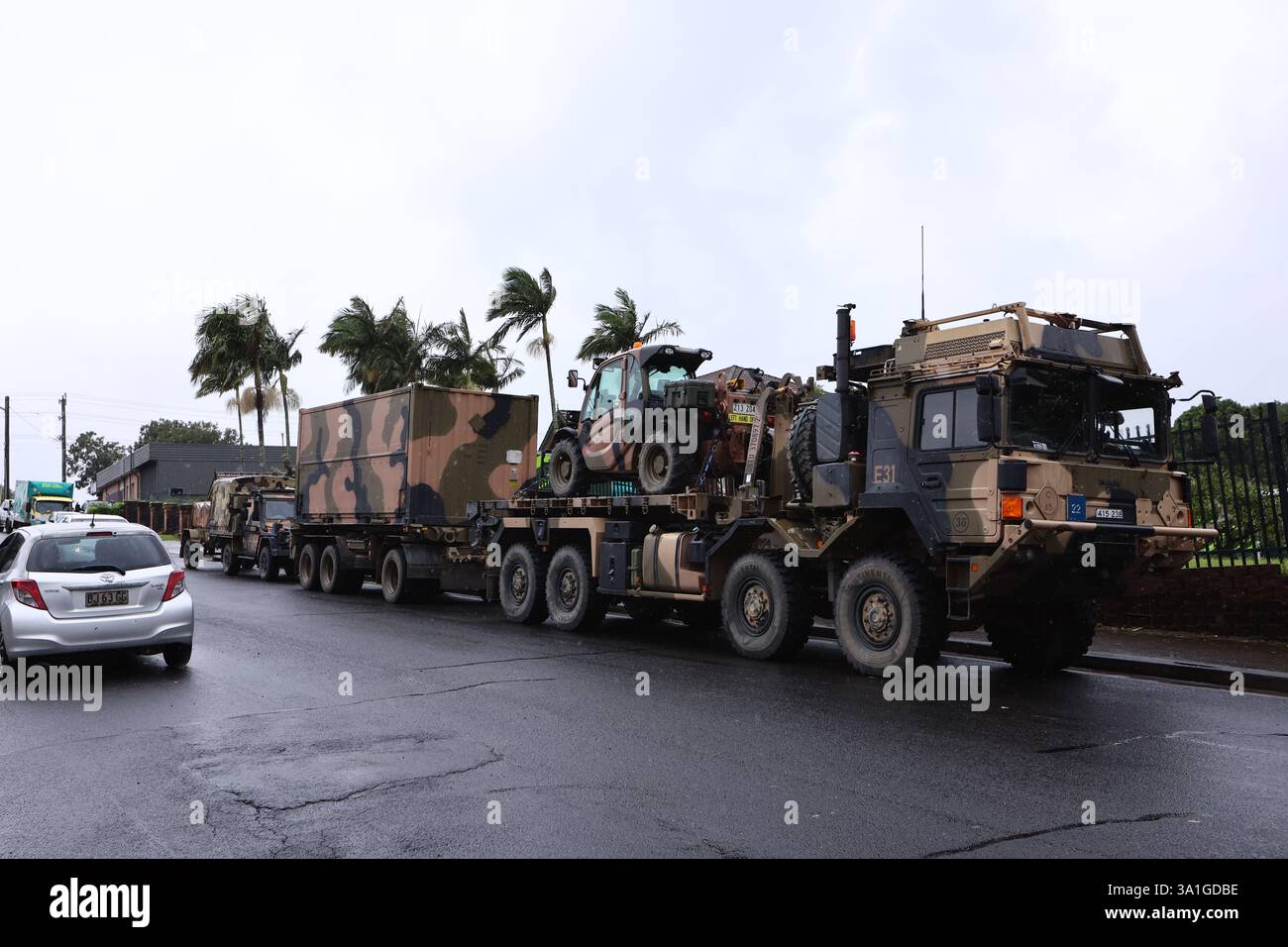 Defence vehichles are seen in Lismore.Millions in NSW and Queensland ...