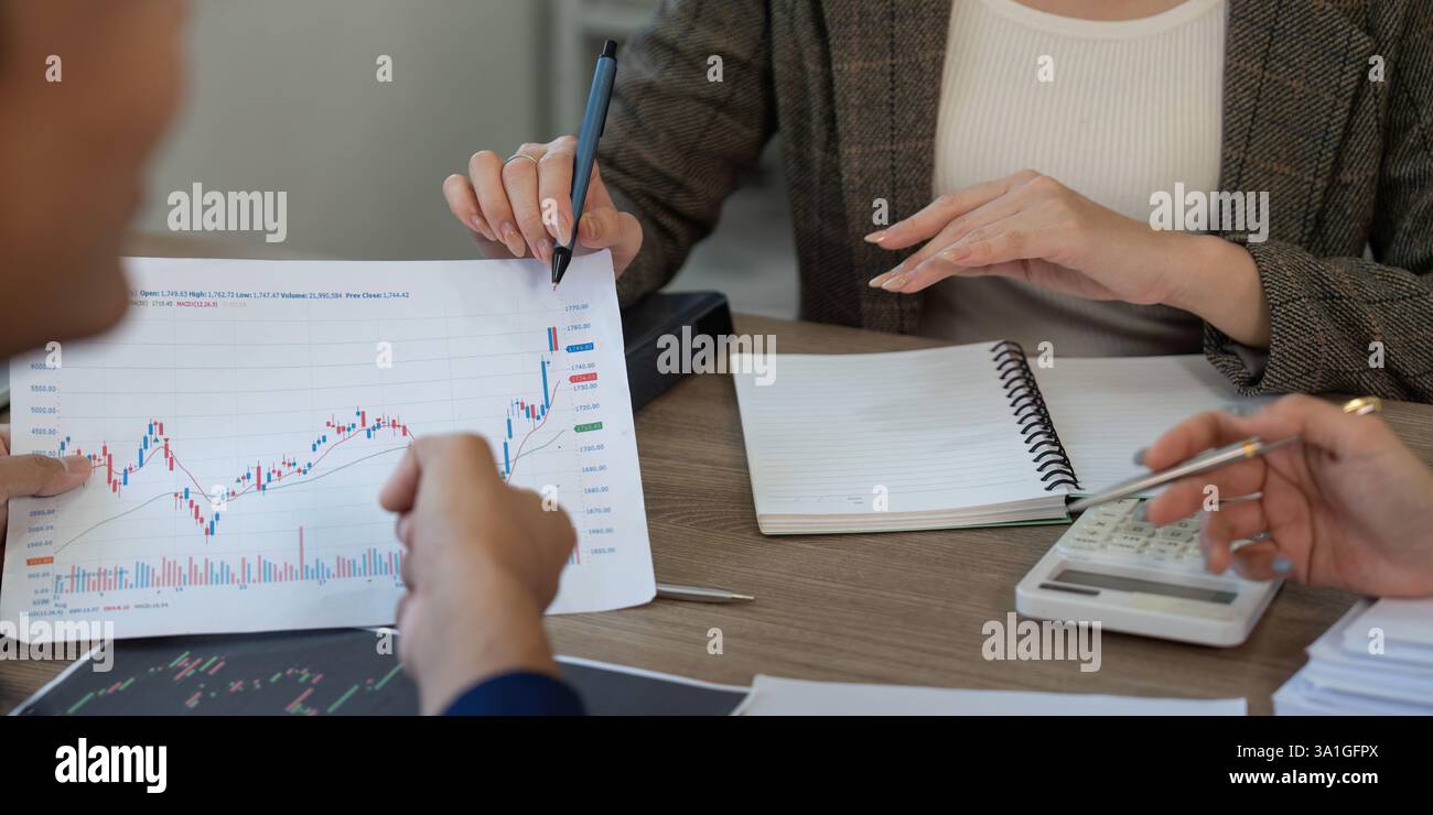 Dynamic teamwork. Tax professionals analyzing reports together ...