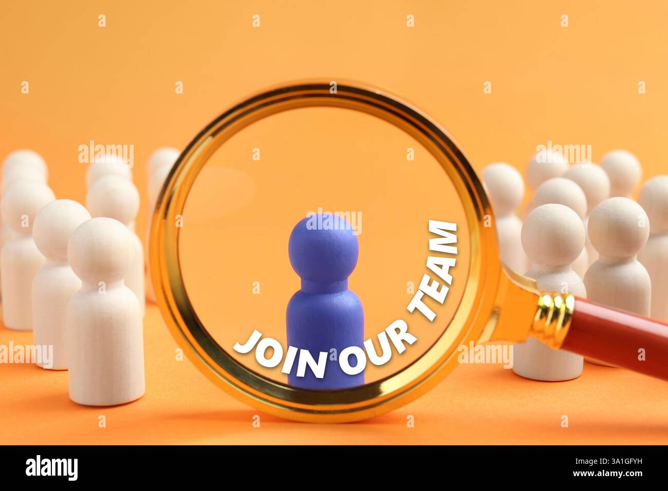 Join Our Team announcement. Blue figure among wooden ones on orange ...