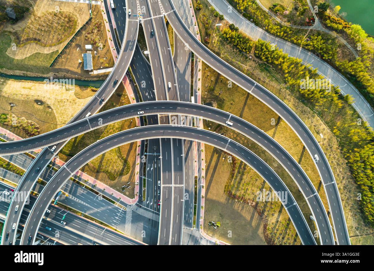 Aerial view of complex highway interchange surrounding lush greenery in ...