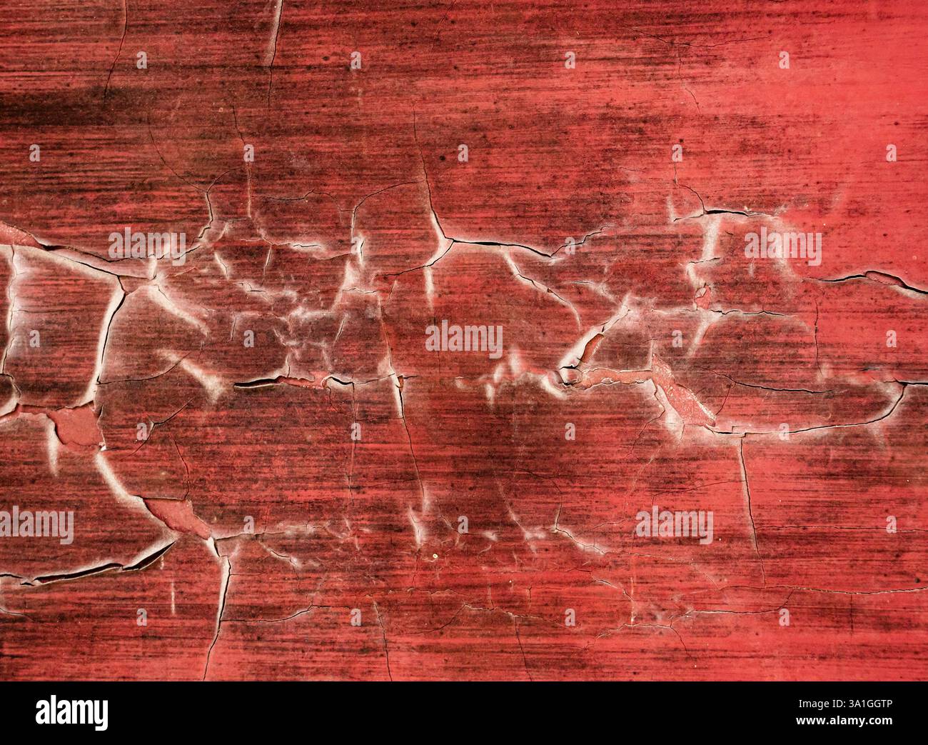 Detailed close-up of cracked red paint revealing textures on an old ...