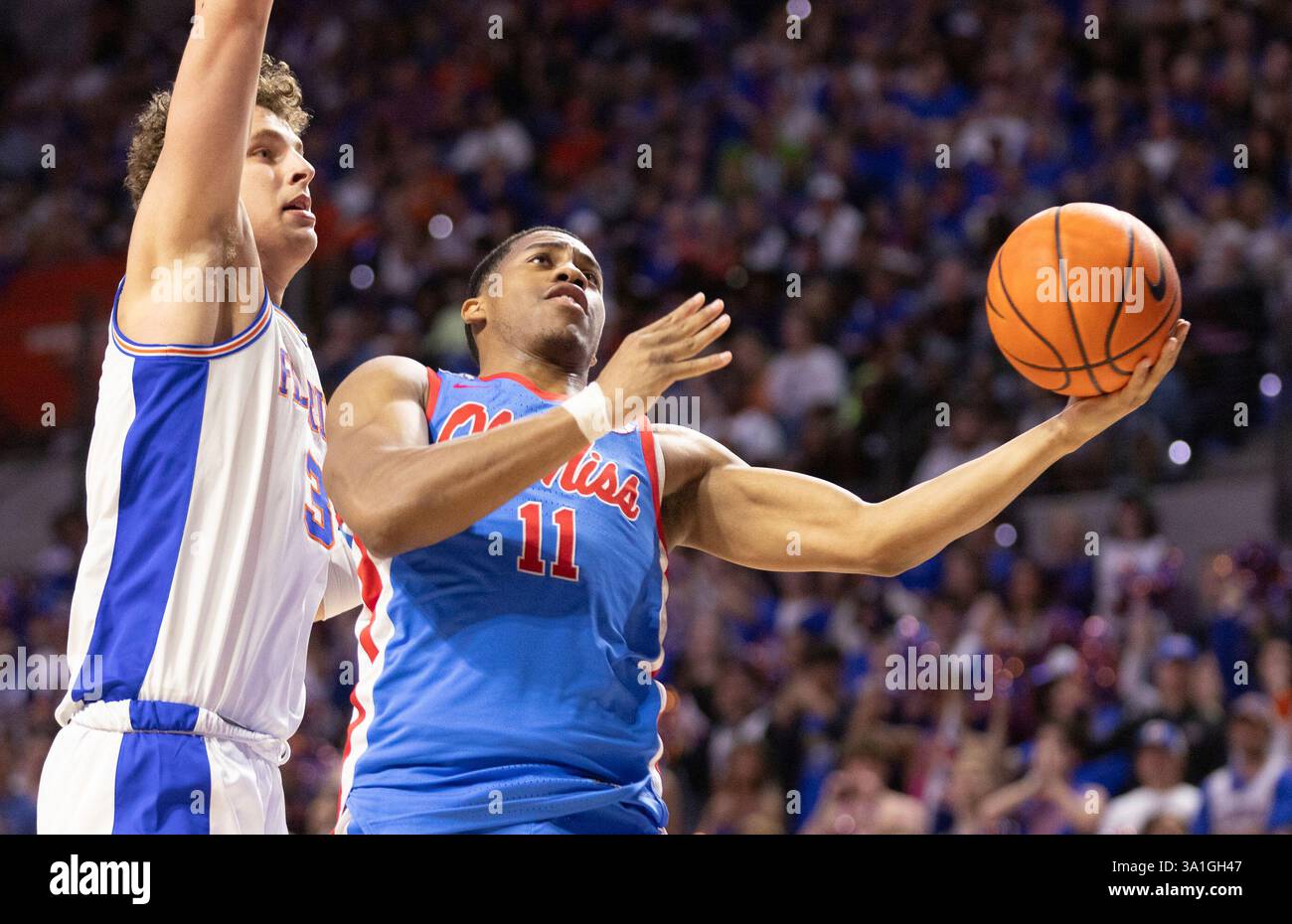 Mississippi guard Matthew Murrell (11) shoots past Florida center Micah ...
