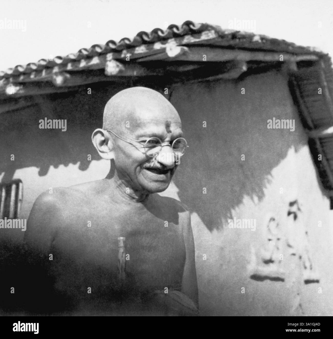 Mahatma Gandhi in front of his hut at Sevagram Ashram, 1942 NO MR Stock ...