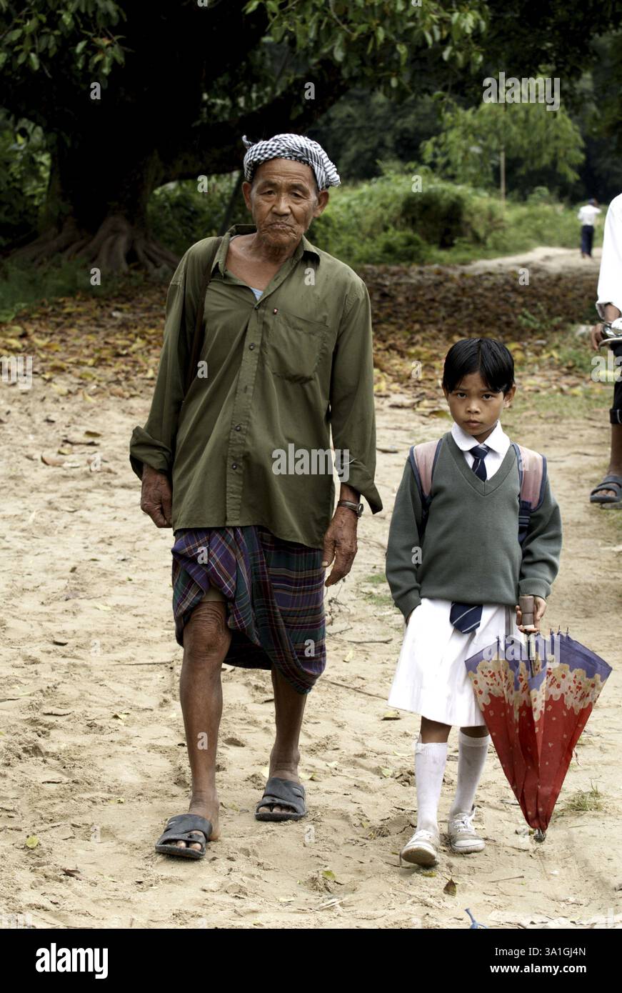 Father accompanying daughter to school, Diyun, Arunachal Pradesh, India ...