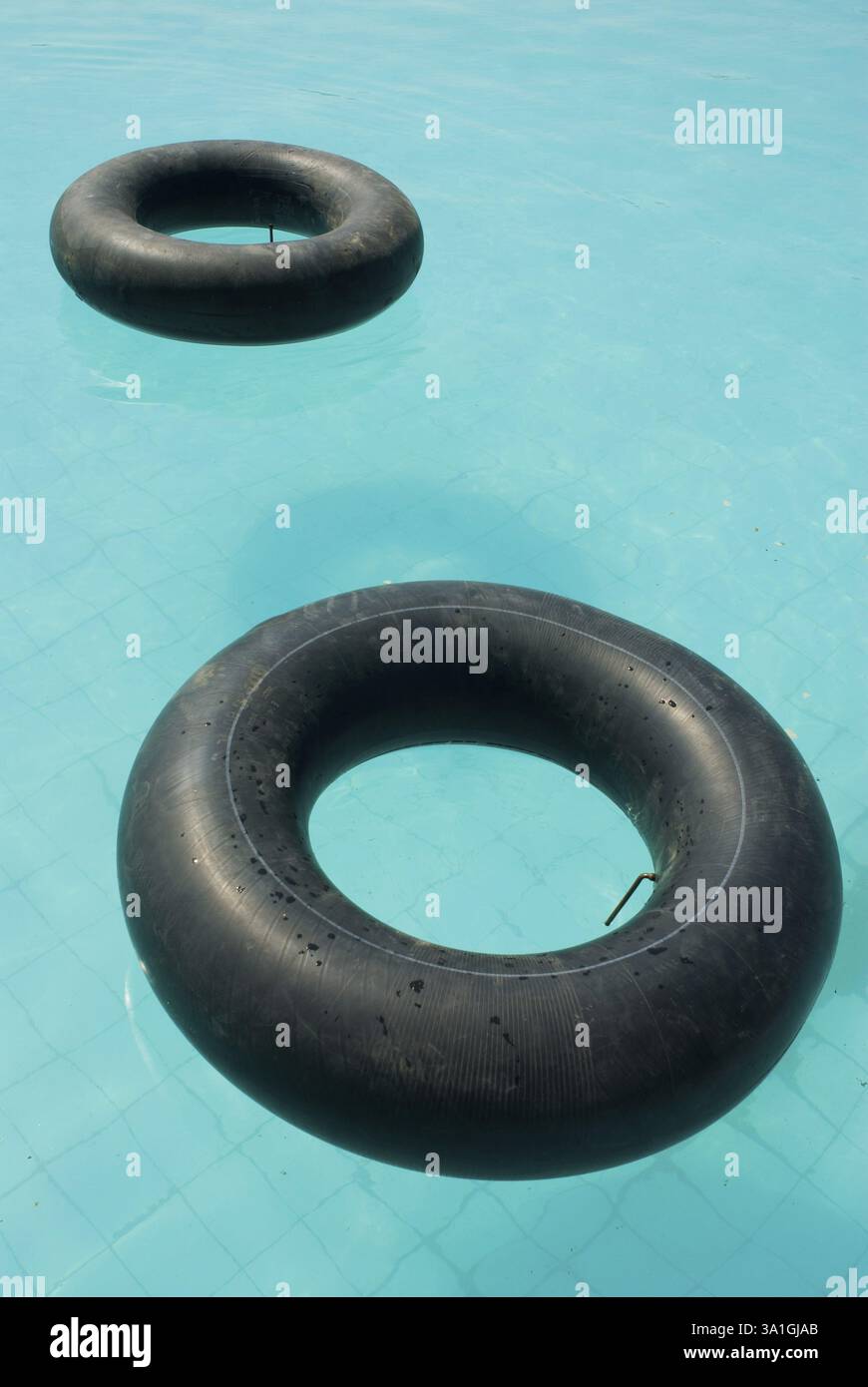 Inflated tires tube in blue swimming pool, Anjar, Kutch, Gujarat, India ...
