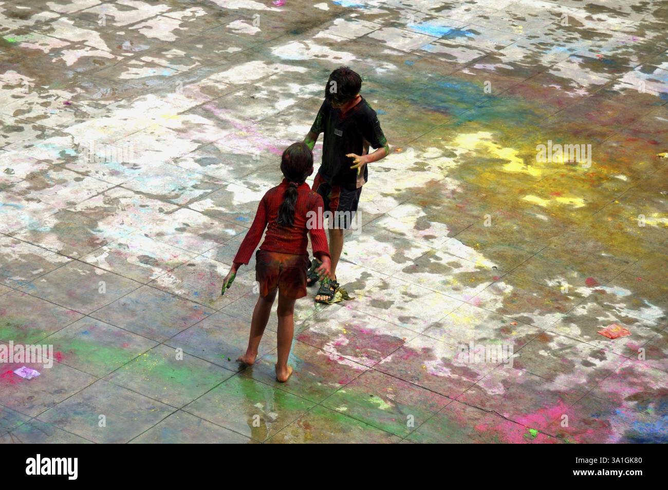 Two children playing Holi festival of color at Ananta apartments at ...