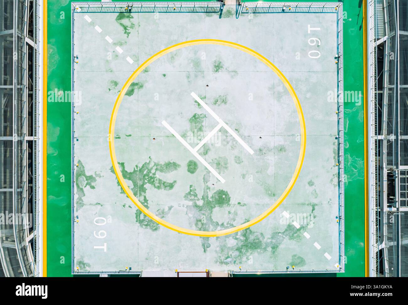 Helicopter landing pad on a rooftop with distinct markings and green ...