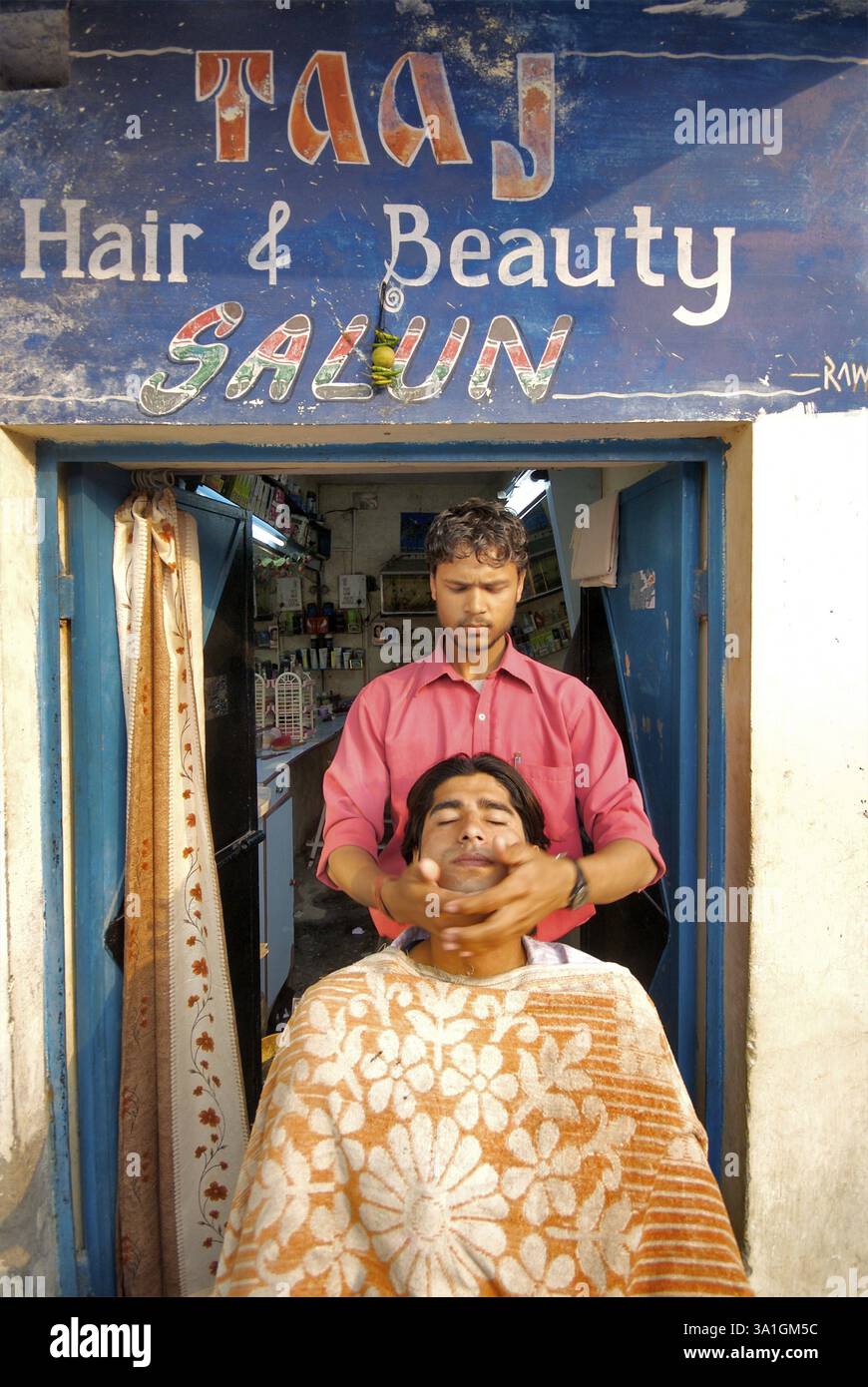 A Young man getting his facial done at Taj hair and beauty saloon ...