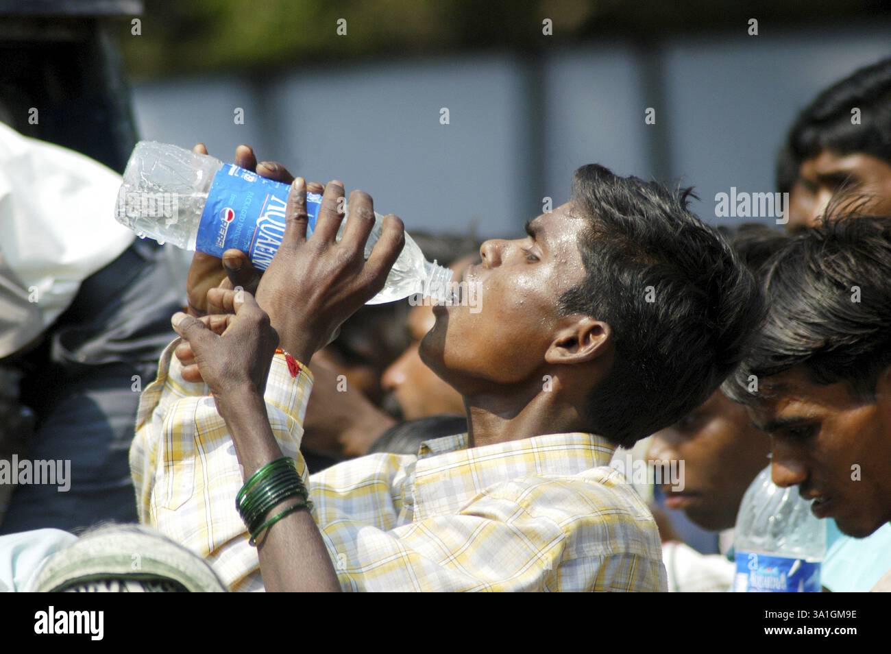 Man quench his thirst by drinking water form plastic bottle, Bombay Mumbai, Maharashtra, India ...