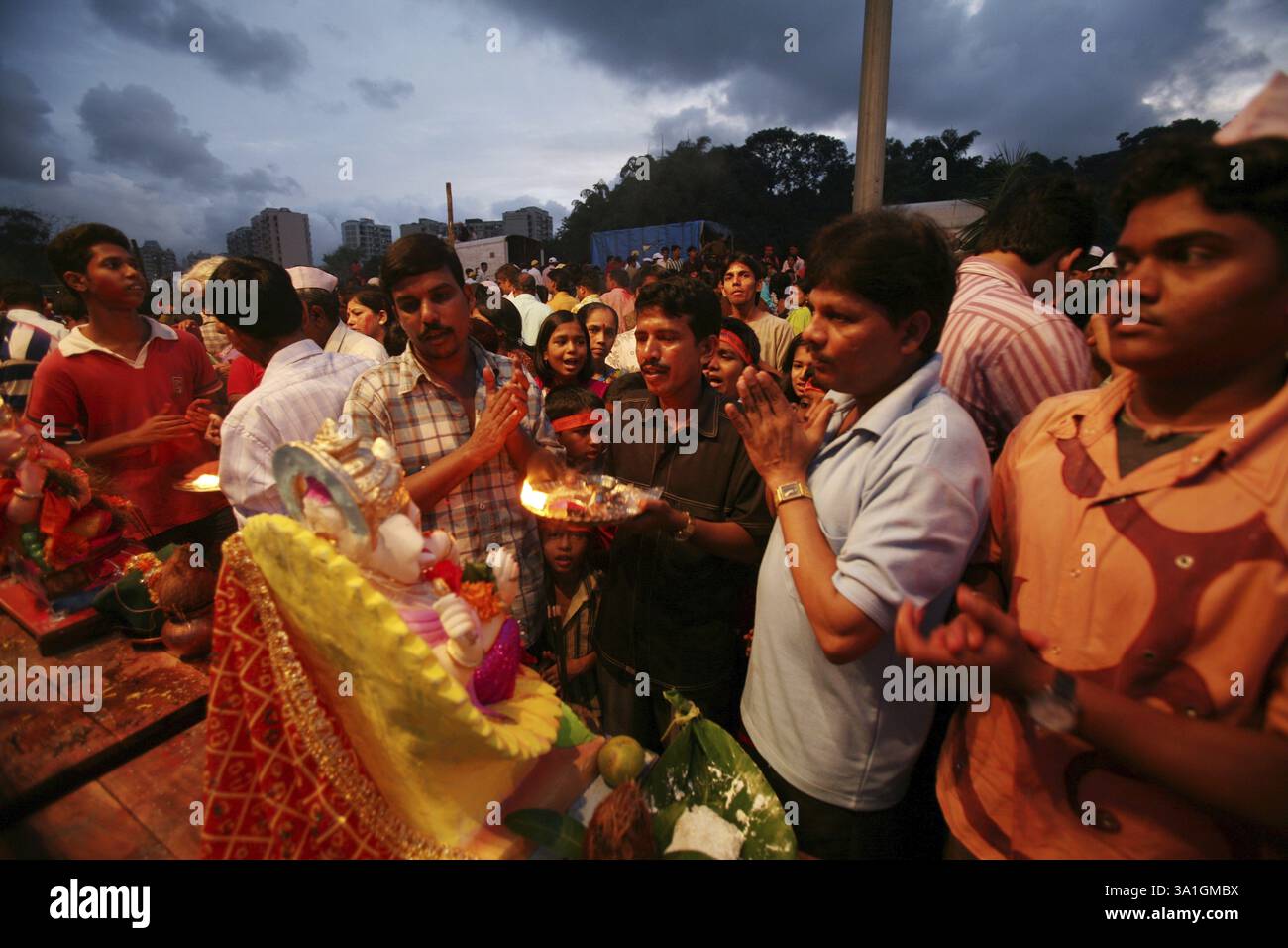 Devotees performing puja of Lord Ganesha ganpati Hindu deity before ...