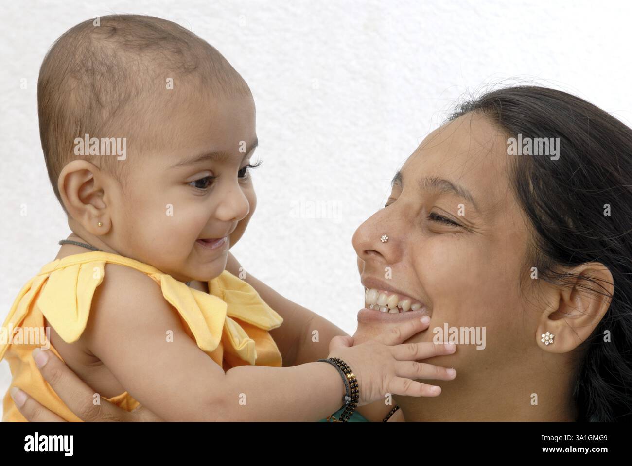 Mother & child, playing, smiling, looking at each other, white ...