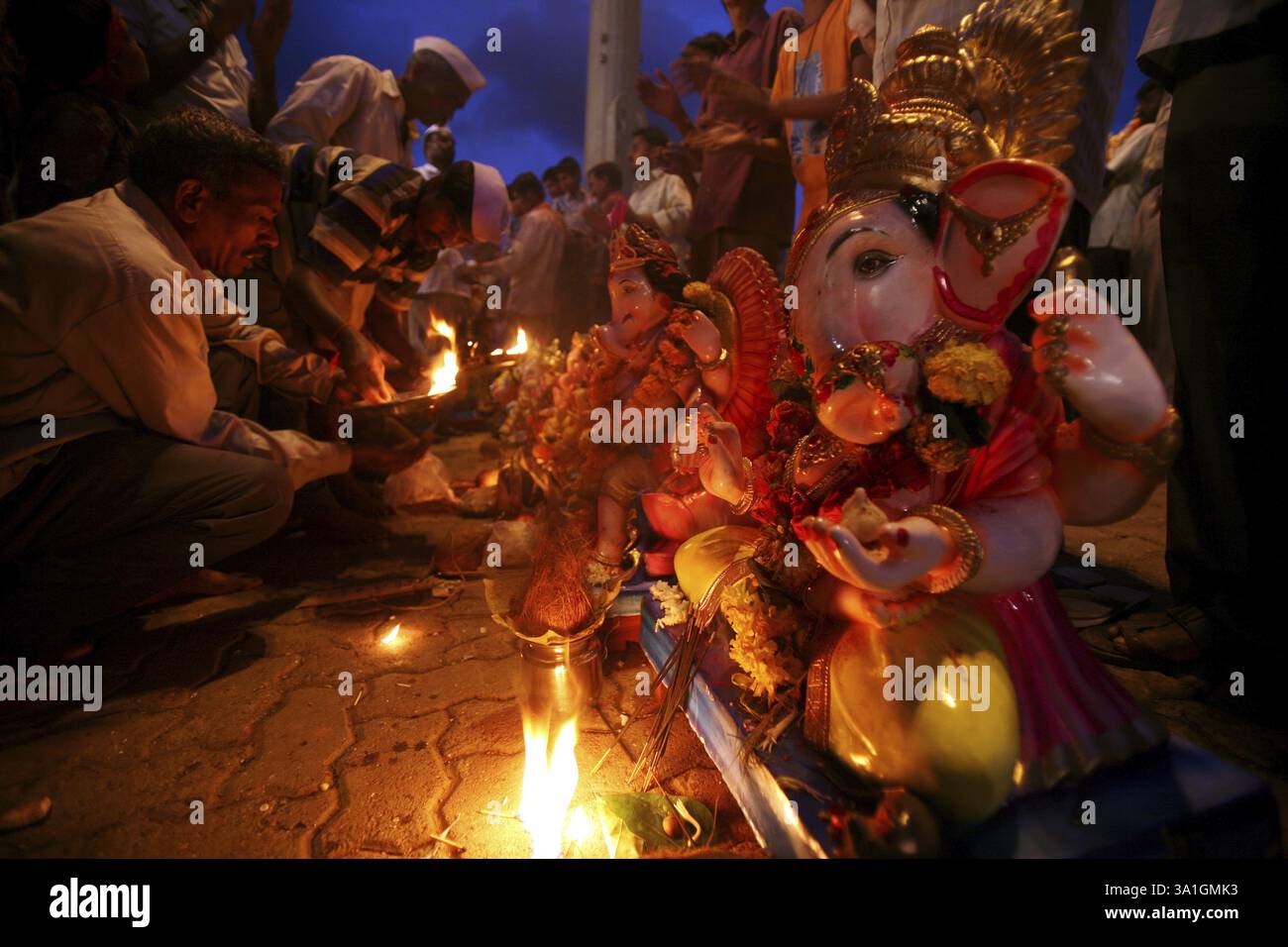 Devotees performing puja of Lord Ganesha ganpati Hindu deity before ...