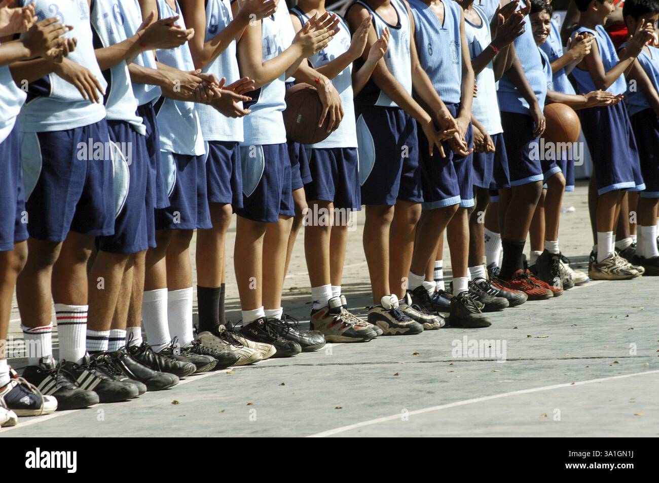 Students standing in queue during basket ball practice session in ...