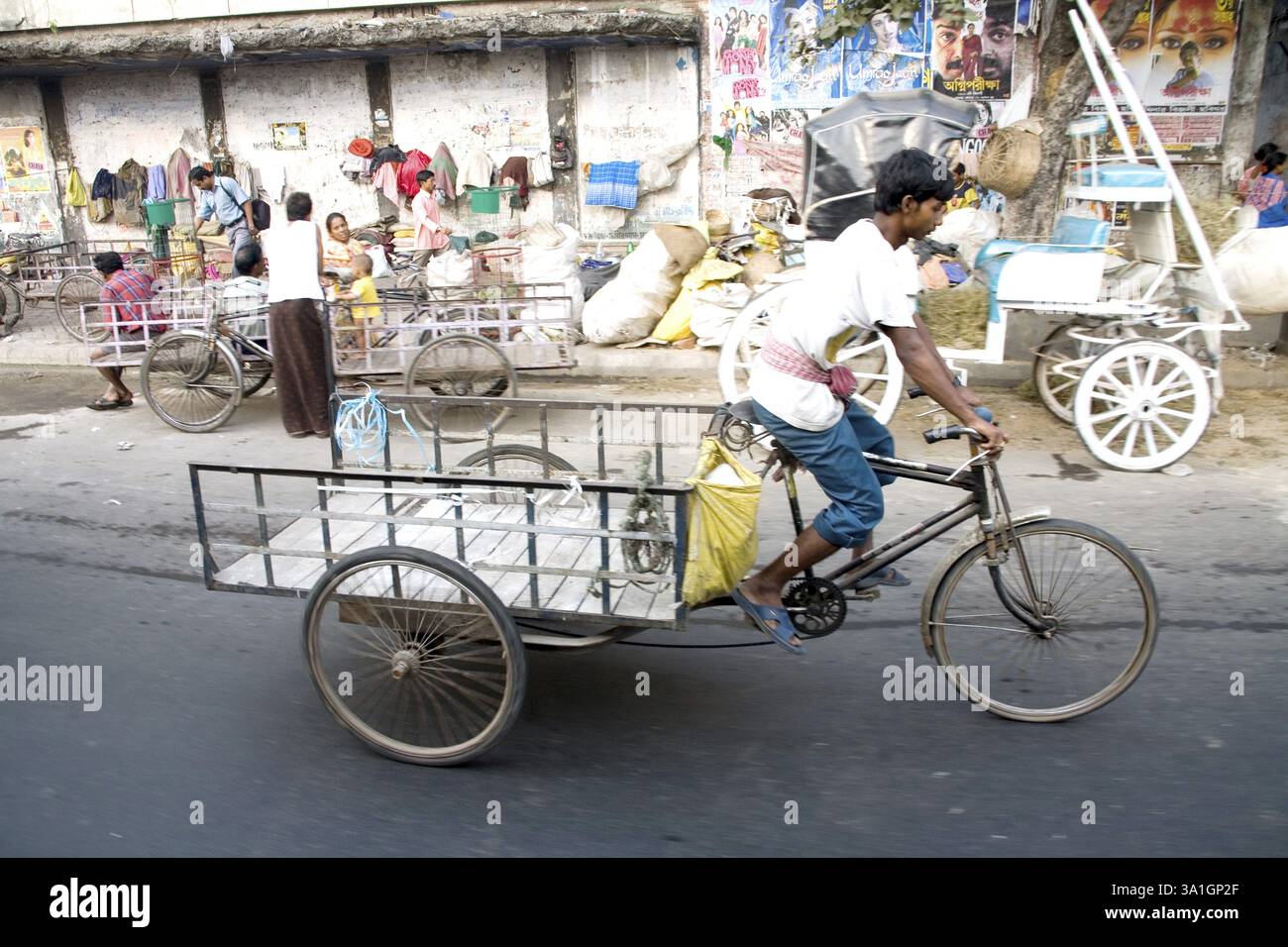 Street scene, cycle rickshaw rider riding empty vehicle, Calcutta now ...