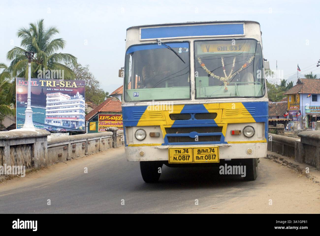 Heavy traffic on narrow bridge on river Pazhayar and village houses ...
