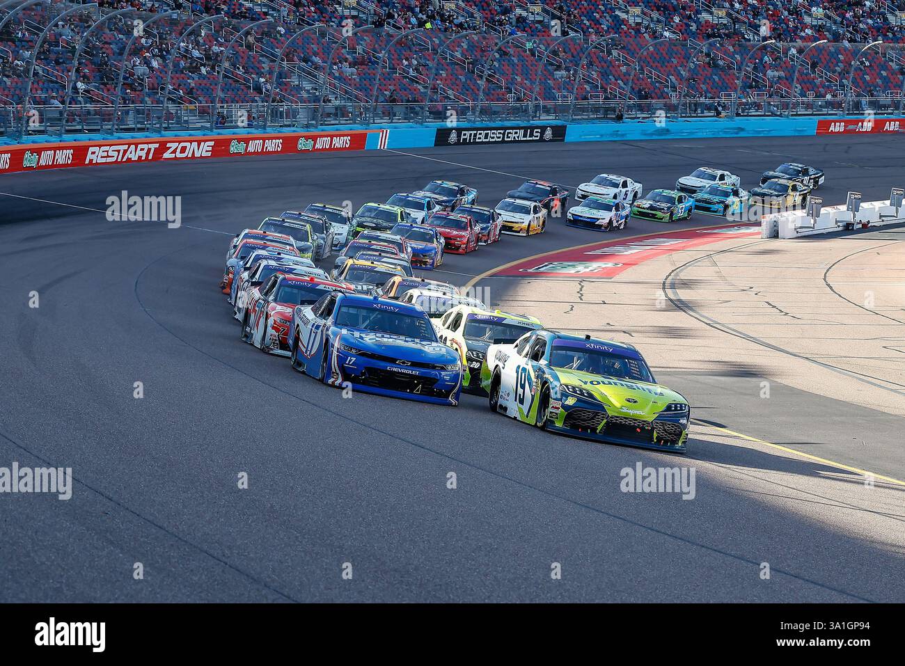 AVONDALE, AZ - MARCH 08: Xfinity cars race during a restart during the ...