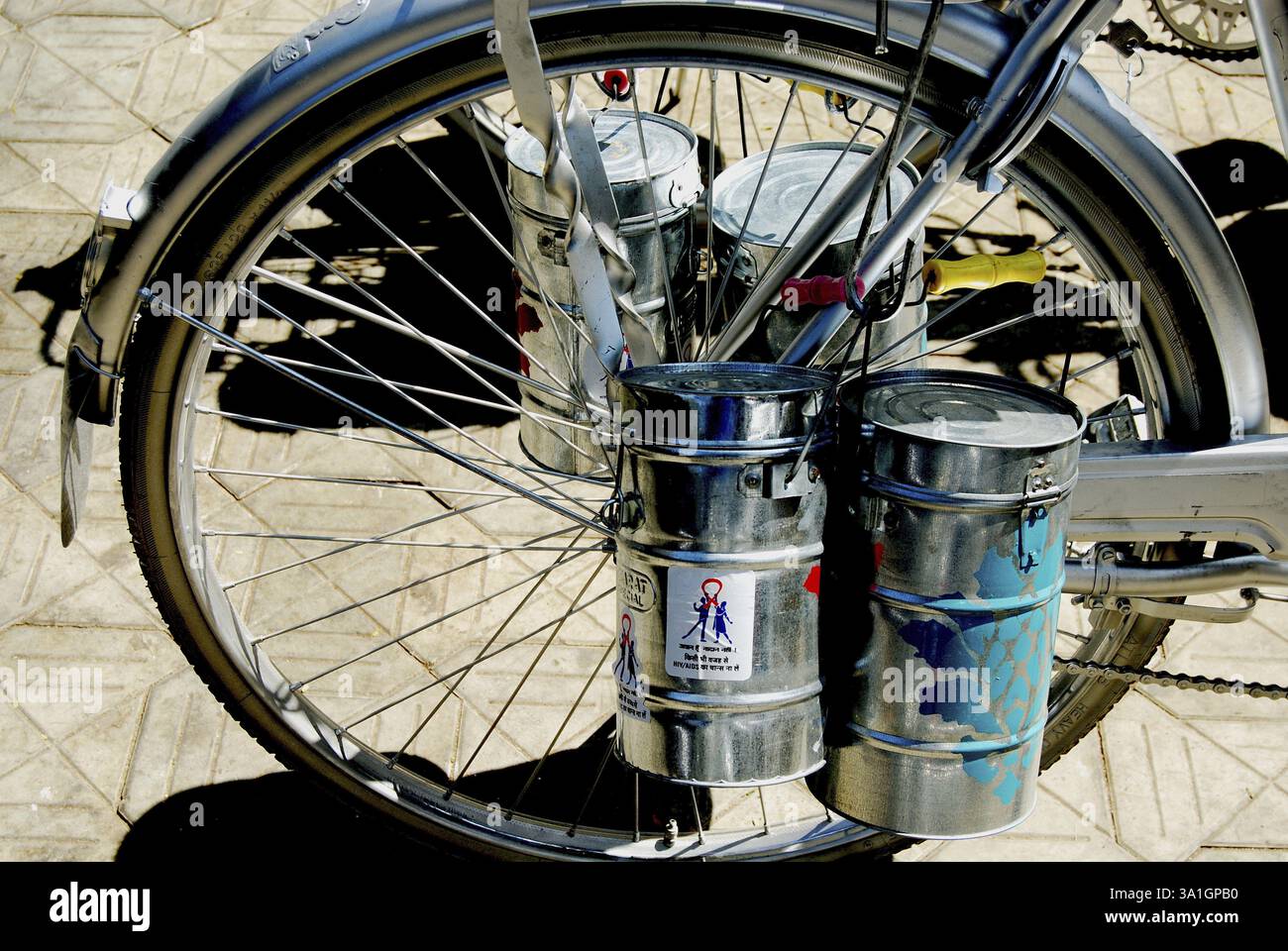 Food dabbas tied to rear wheel of cycle Stock Photo - Alamy