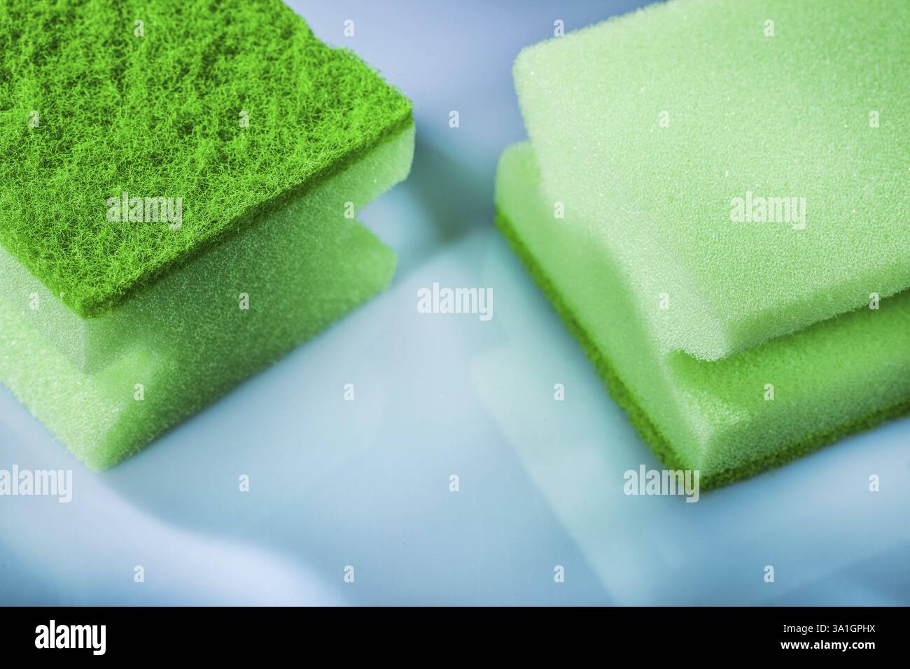 New green kitchen sponges on white background Stock Photo - Alamy