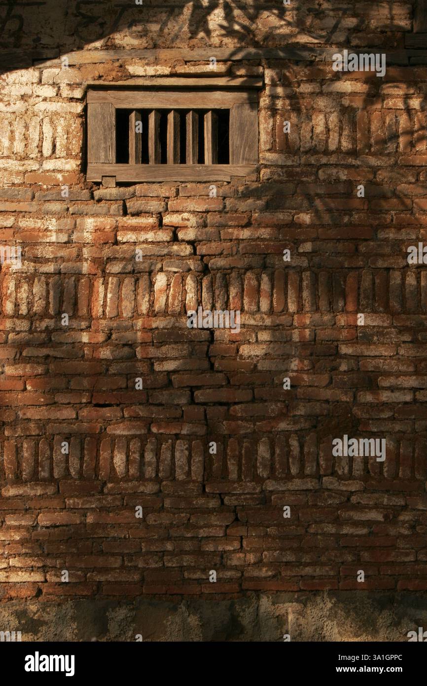 Abstract of bricked wall with lots of texture and small window having ...