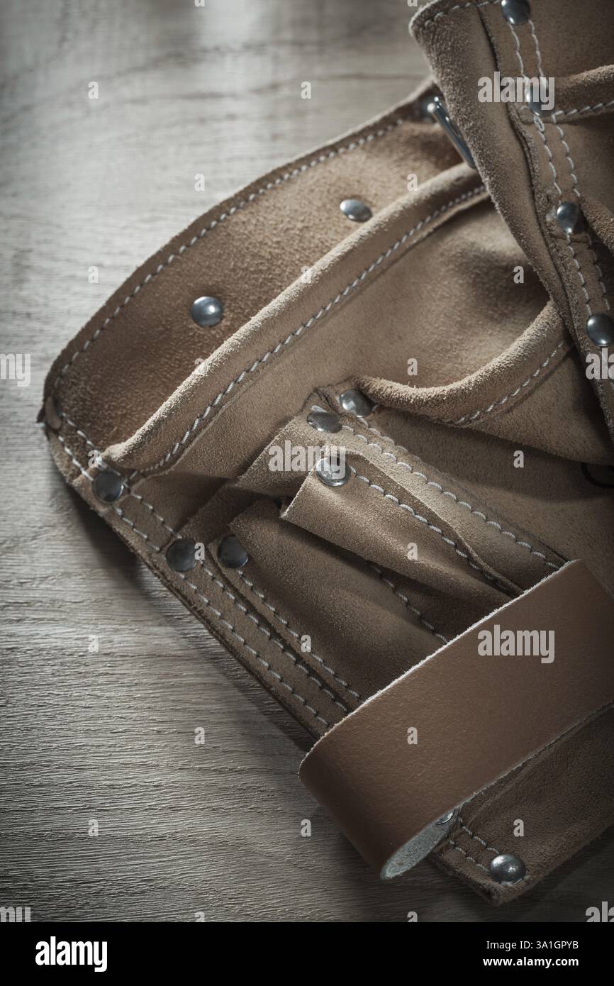 Leather construction belt on wooden board Stock Photo - Alamy