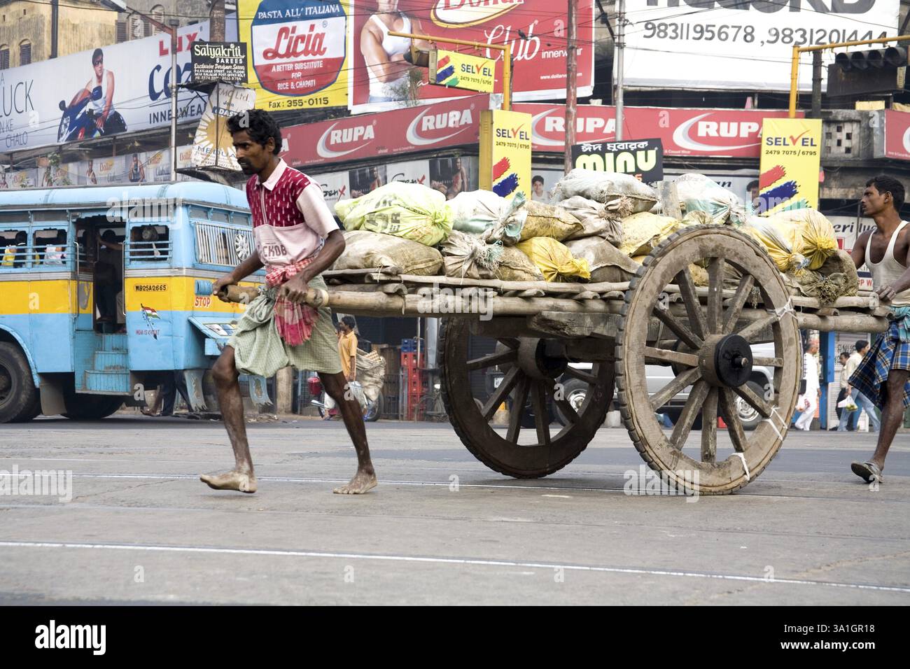Street scene, men pulling heavy handcart, Calcutta now Kolkata, West ...
