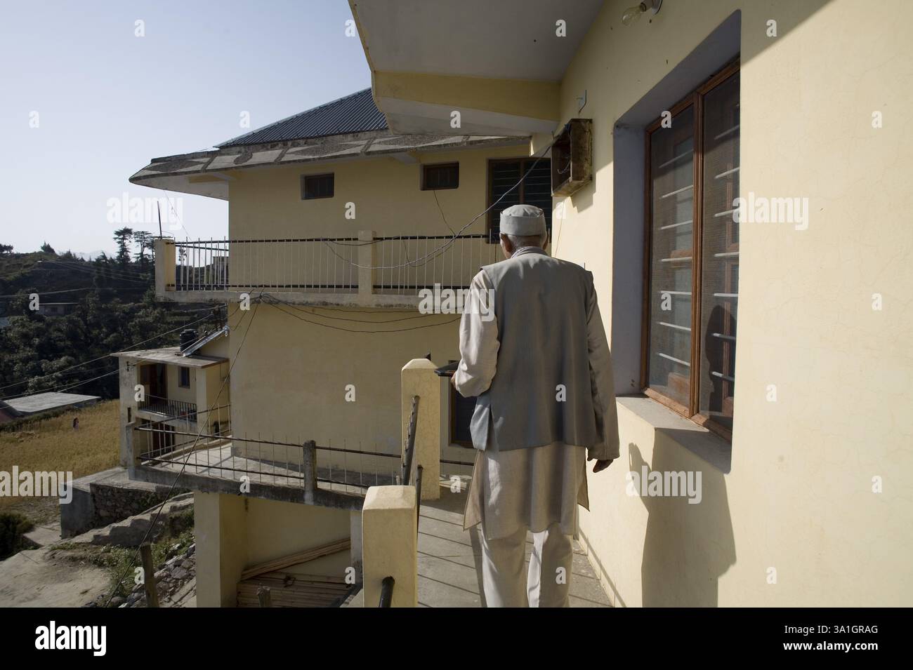 Old man standing in balcony in Himalaya house, Village Nagthat ...