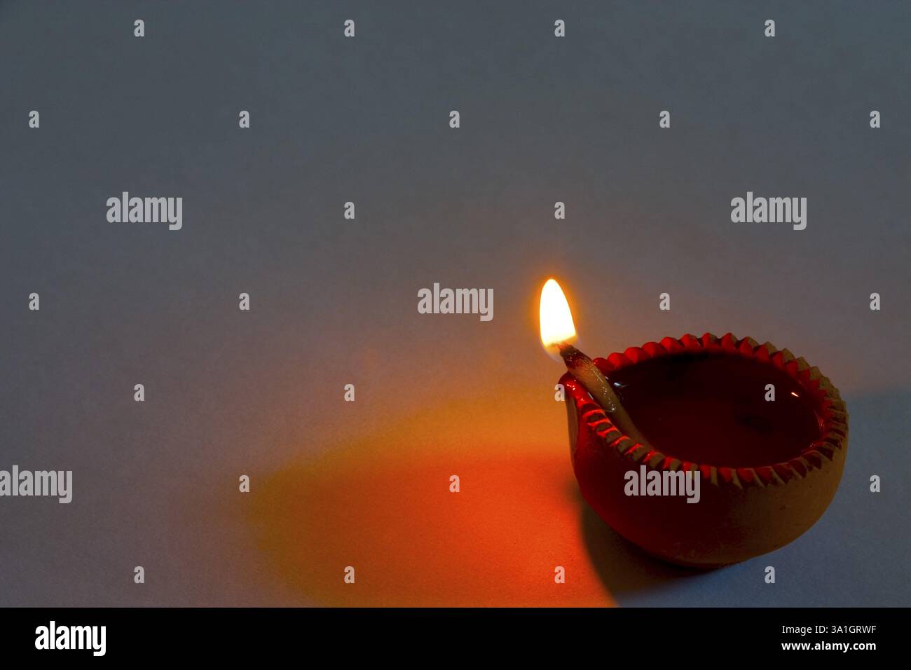 One diya clay oil lamp a source of light as flame on white background ...