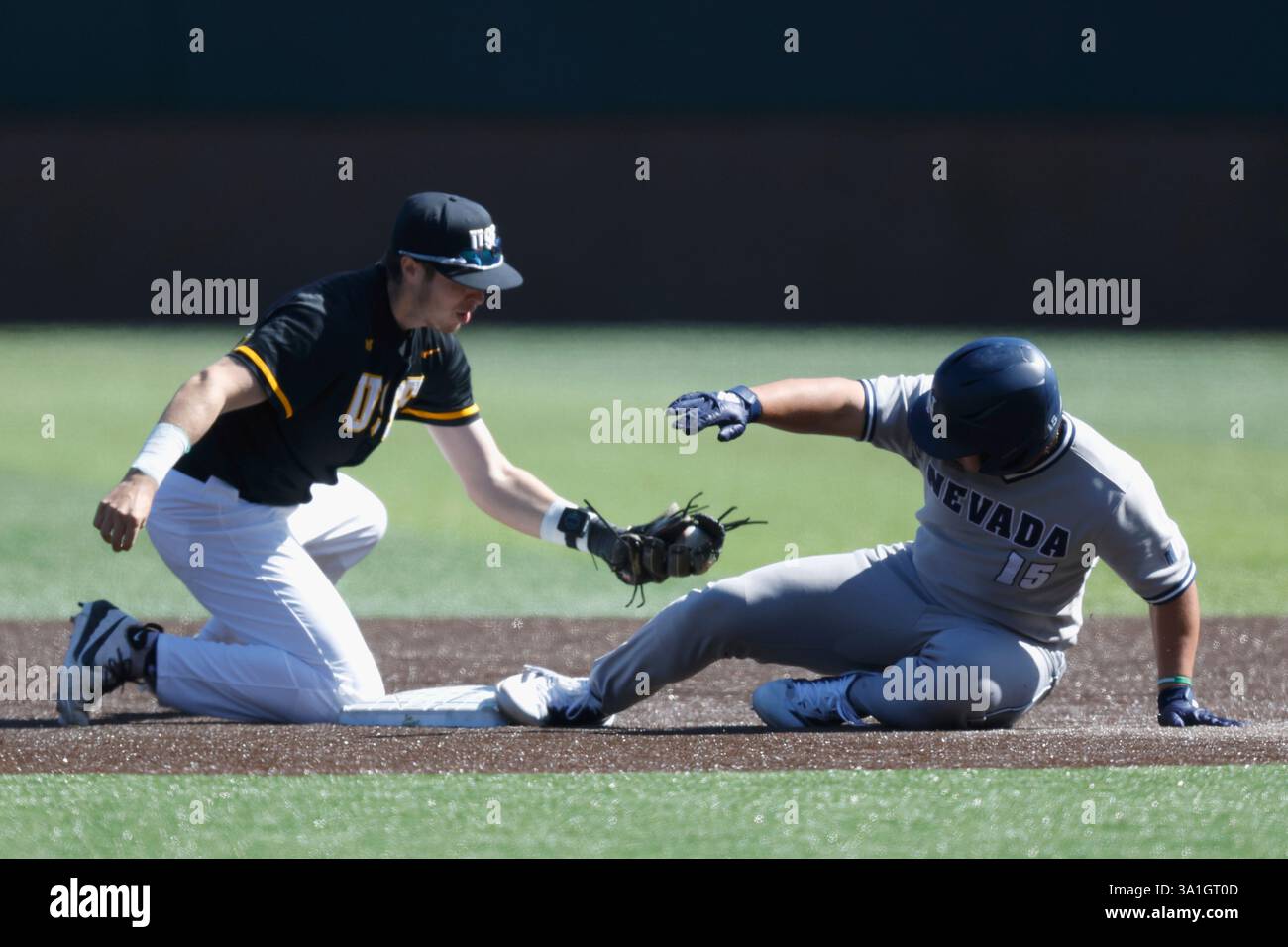 Nevada base runner Sean Yamaguchi (15) slides safely into second base ...