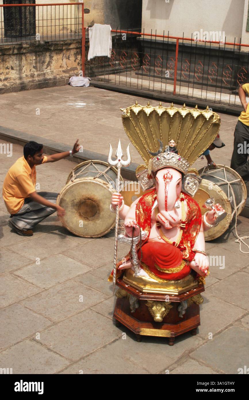 Idol of lord ganesh elephant headed god in compound with man and ...