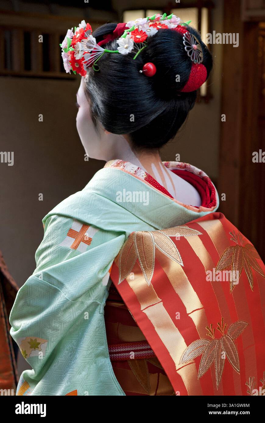 A Japanese maiko, or apprentice geisha or geiko, at an okiya teahouse ...