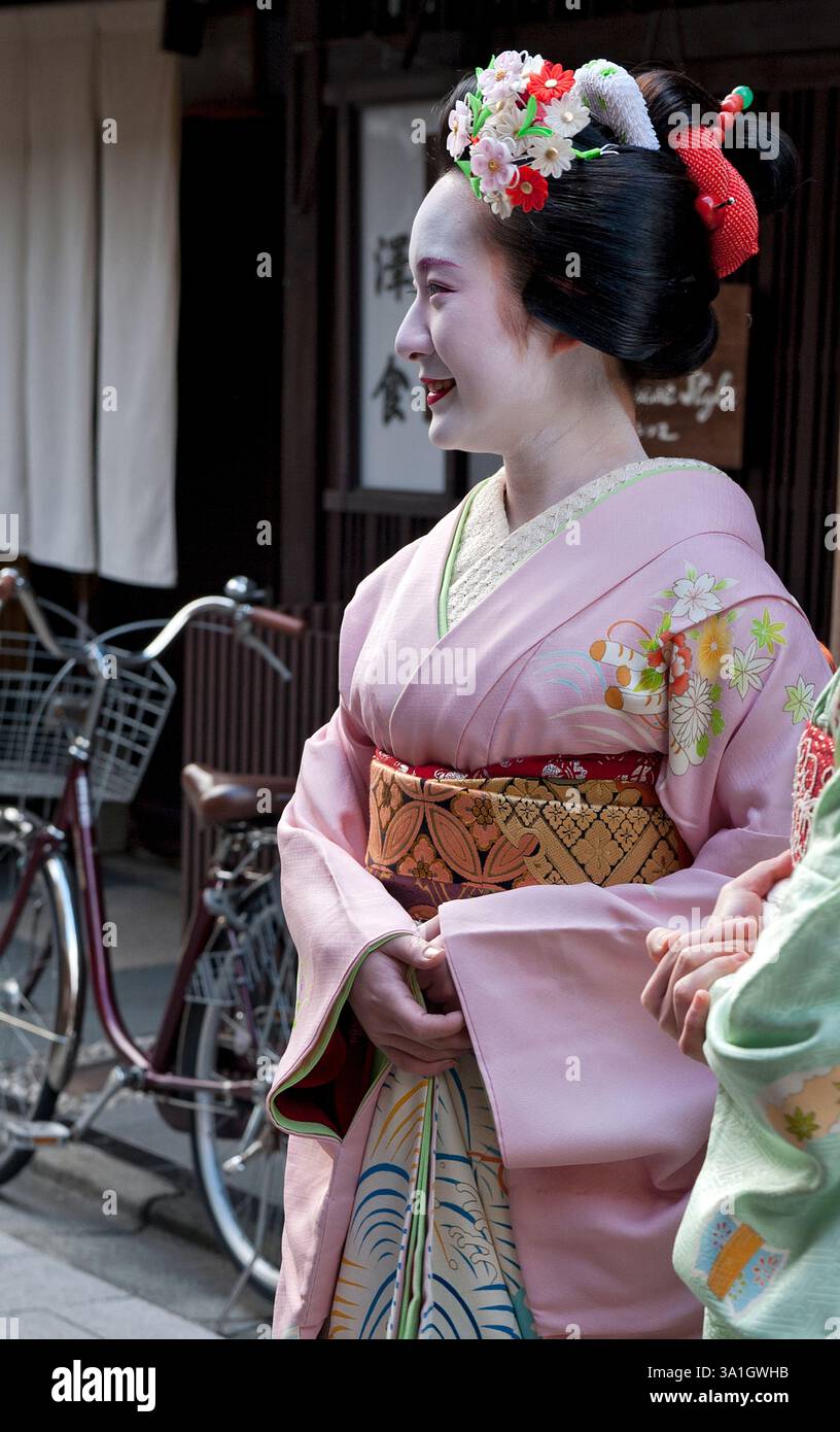 A Japanese maiko, or apprentice geisha or geiko, at an okiya teahouse ...