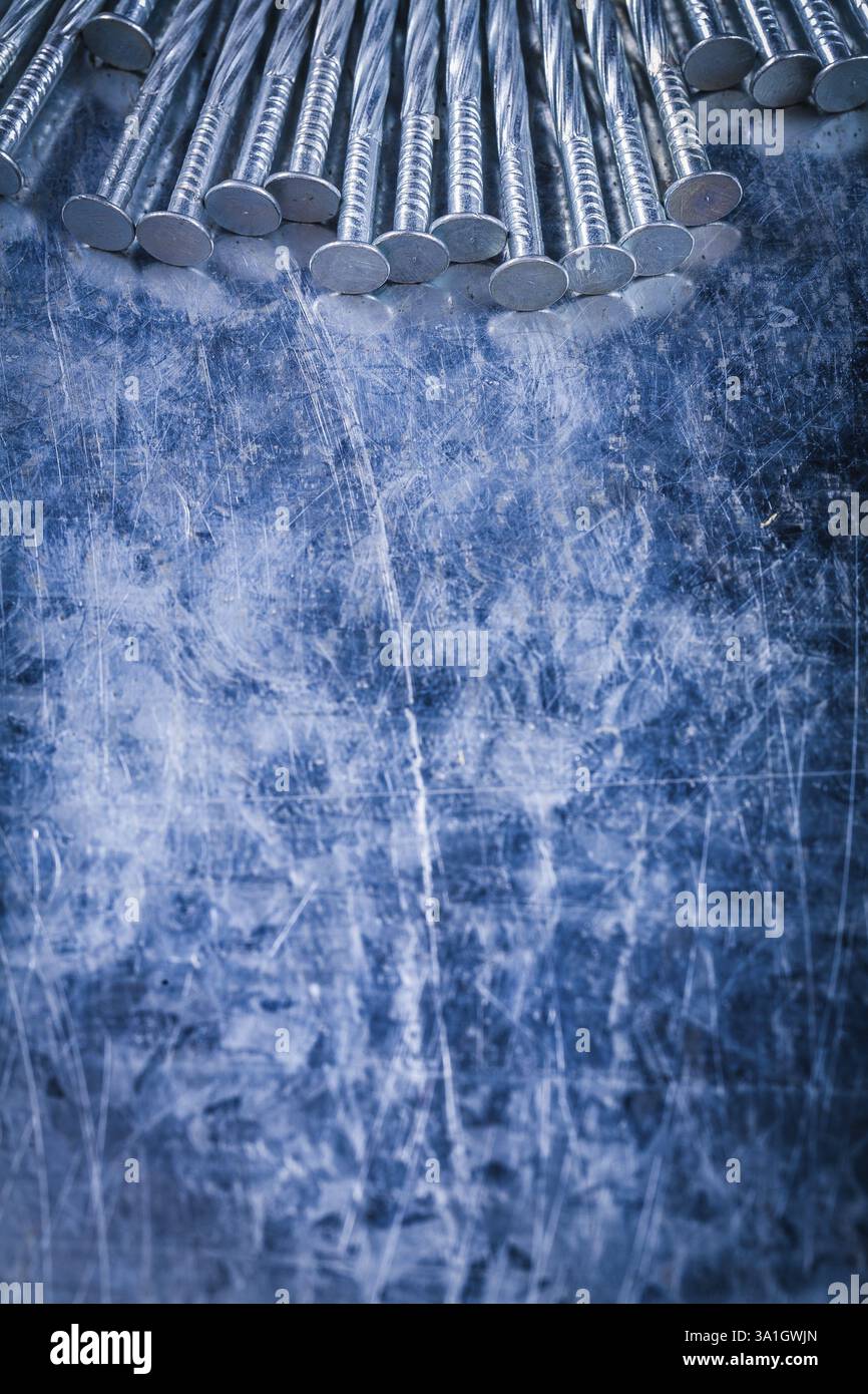 Group of metal construction nails on scratched metallic background copy ...