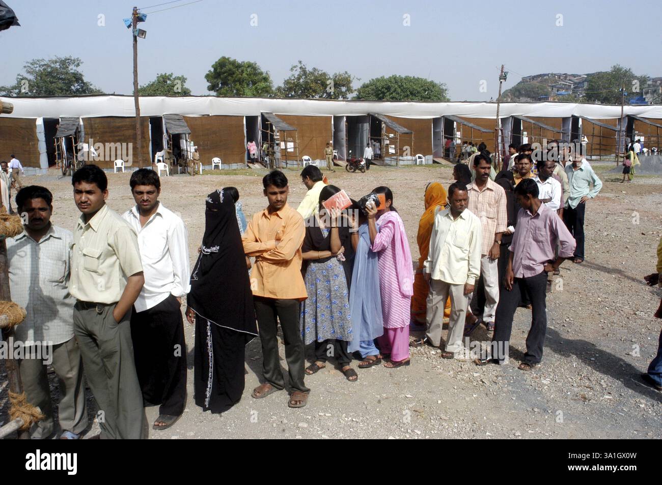 People standing in queue to cast their vote outside a polling booth ...