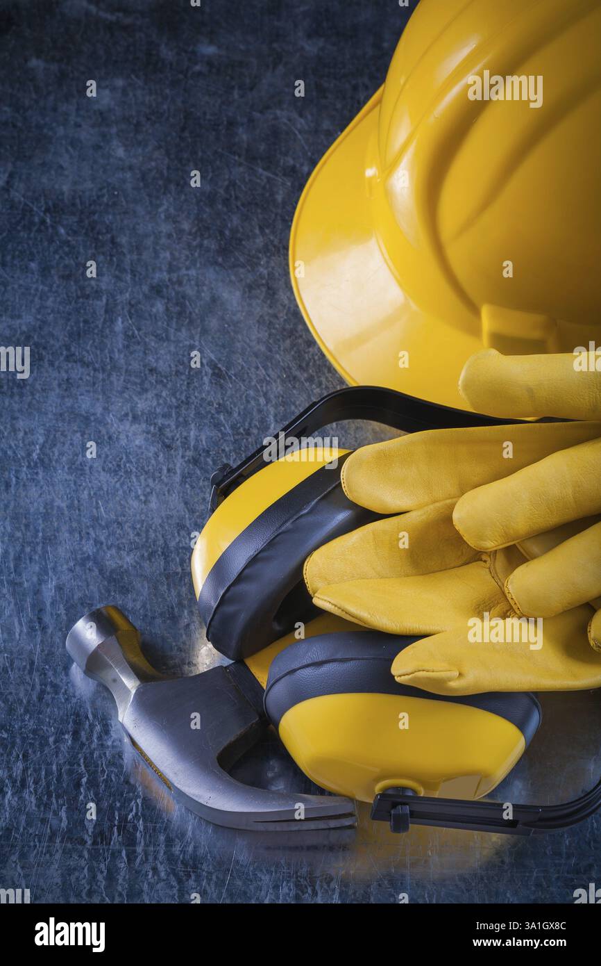 Hard hat ear muffs leather protective gloves and claw hammer on ...
