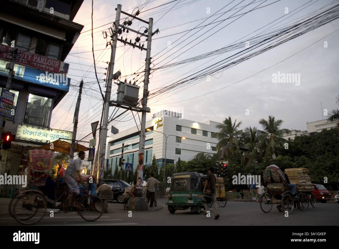 Evening street scene, electric pole transformer on road criss cross ...