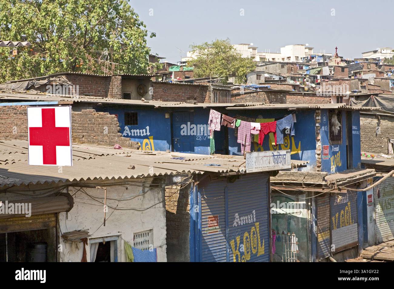 Prominent sign of doctor's clinic on roof top of slum poor living and ...