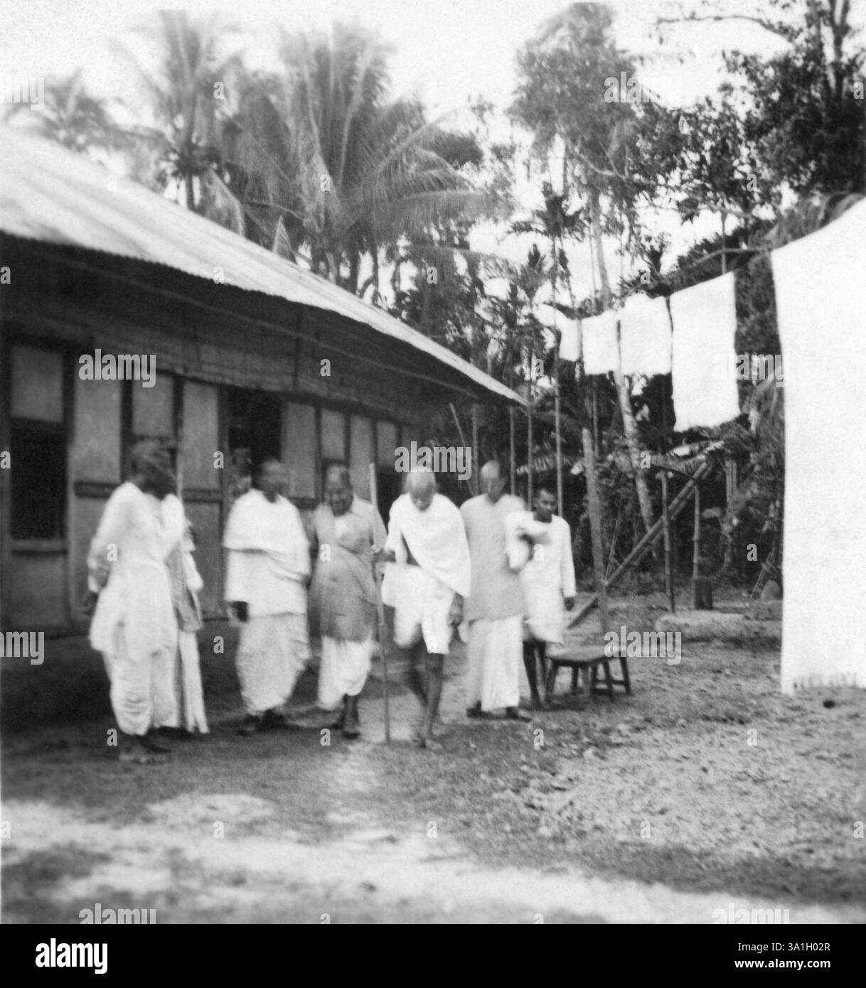 Mahatma Gandhi and others in front of a hut in Noakhali East Bengal ...