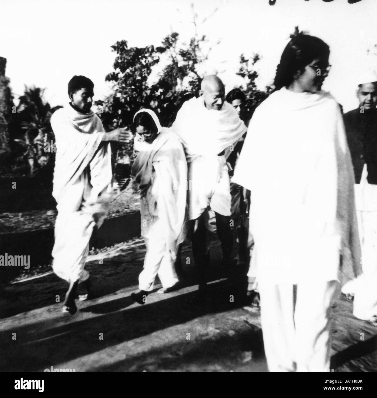 Amtus Salam, Mahatma Gandhi, Manu Gandhi and others walking with others ...