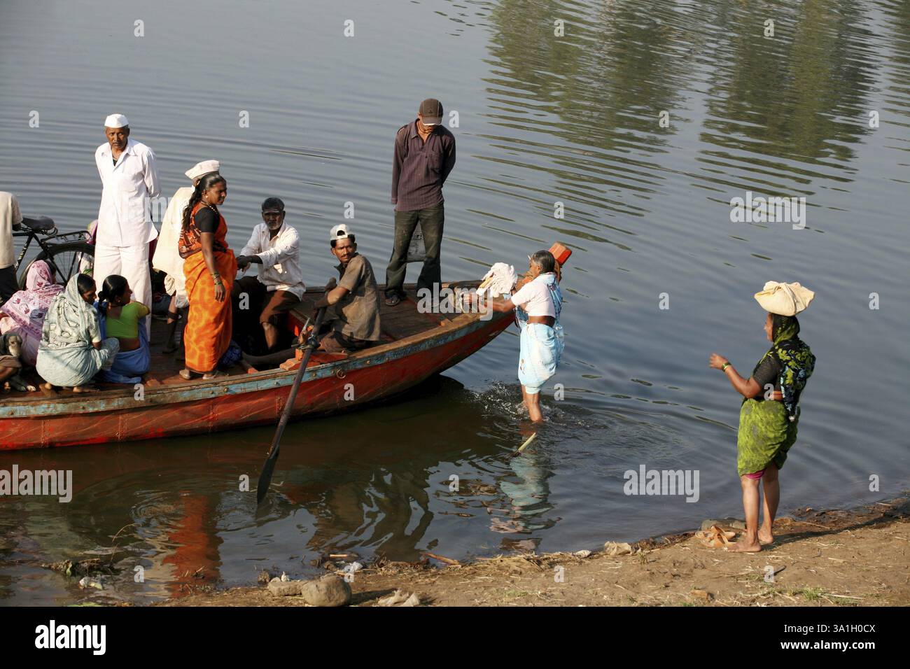 Villagers of the Haripur village loading their bicycles on a boat ...