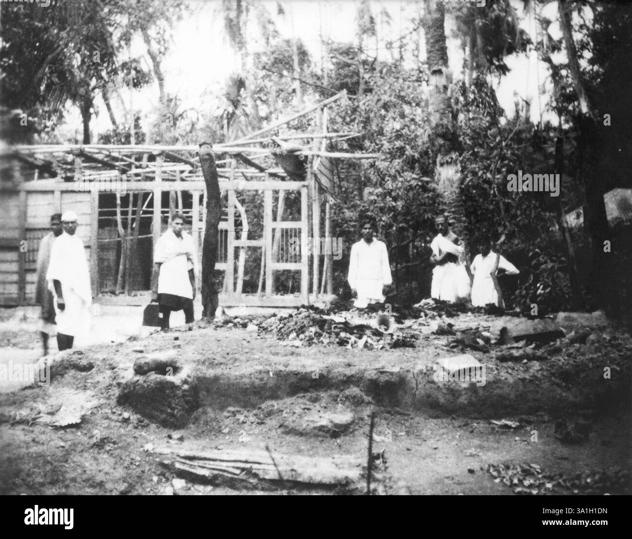 People watching the destruction caused by riots between Hindus and ...