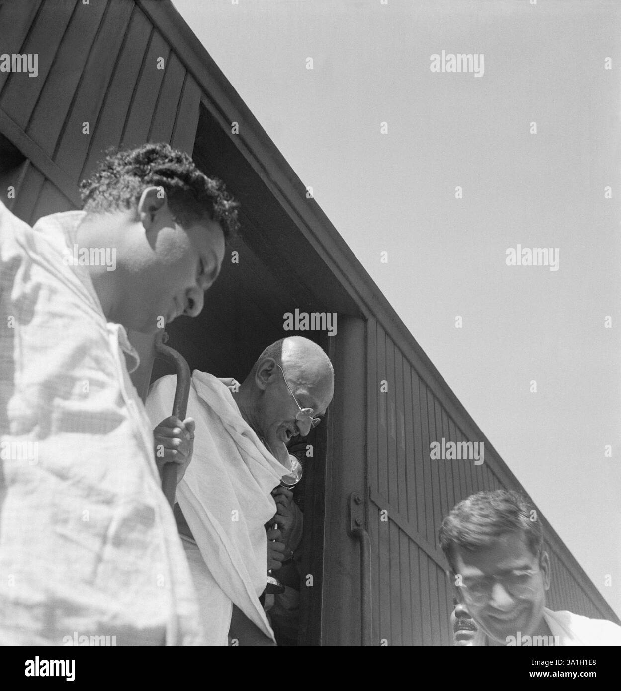 Mahatma Gandhi, alighting from a 3rd class train compartment, Madras ...