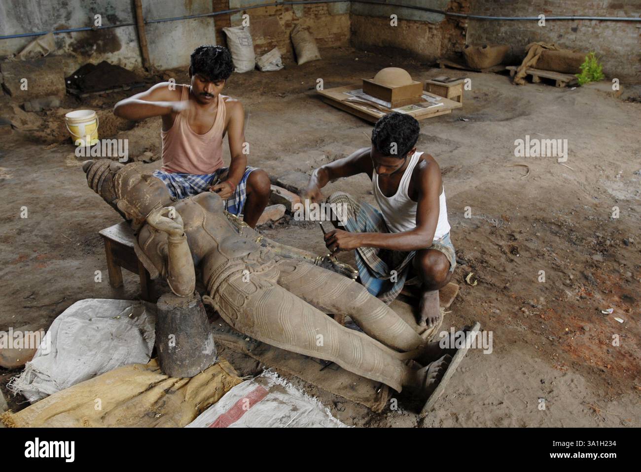 Sculptors carved bronze icon with chisel Stock Photo - Alamy