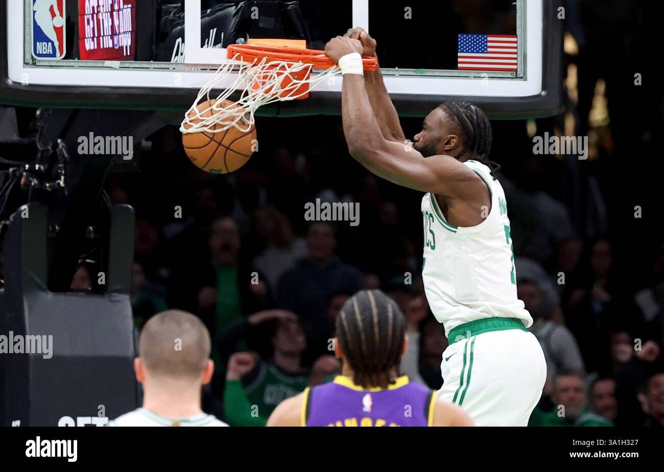 Boston Celtics guard Jaylen Brown, right, dunks during the first half ...